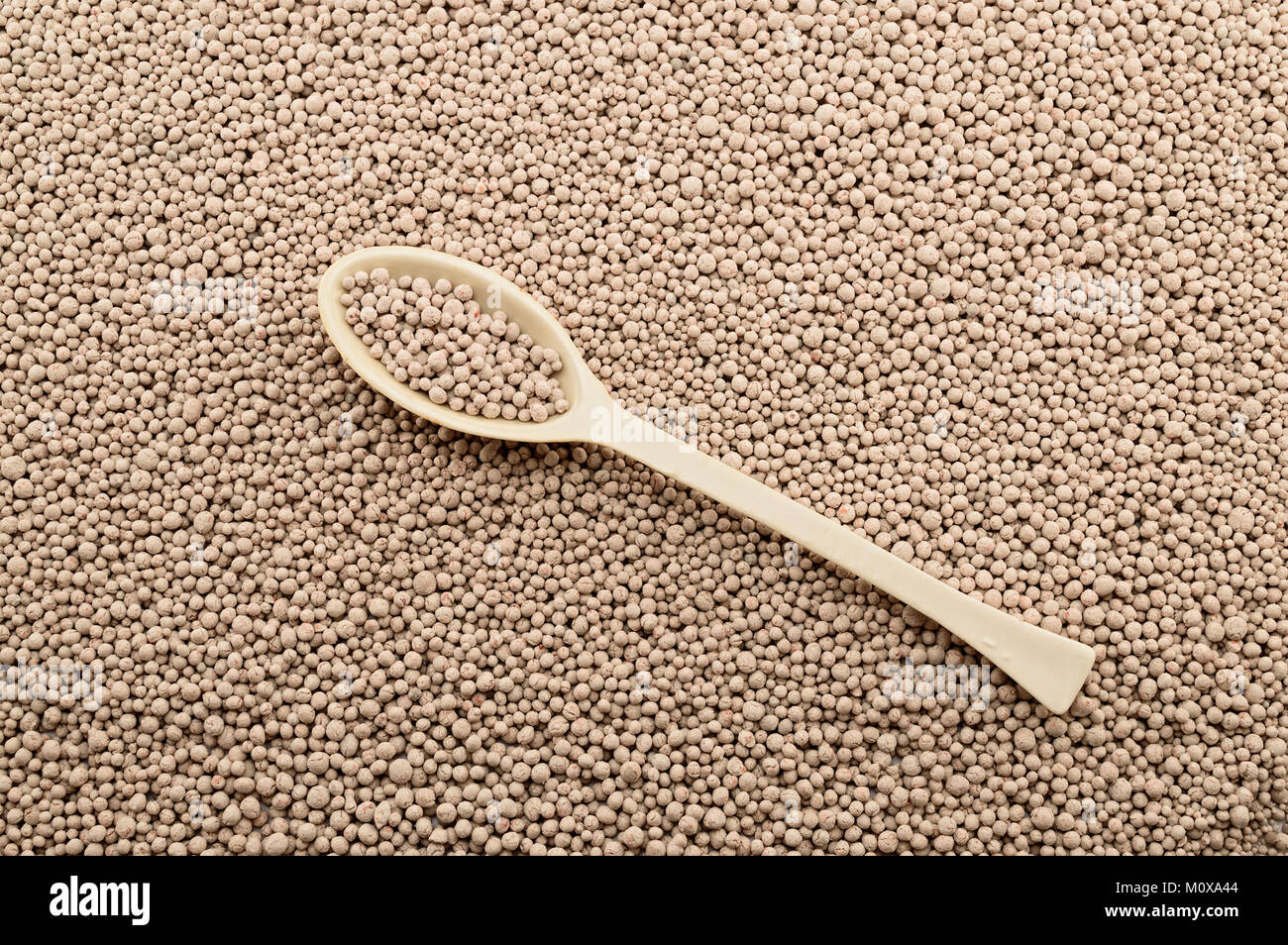 Porcelain laboratory spoon on composite mineral fertilizers Stock Photo ...