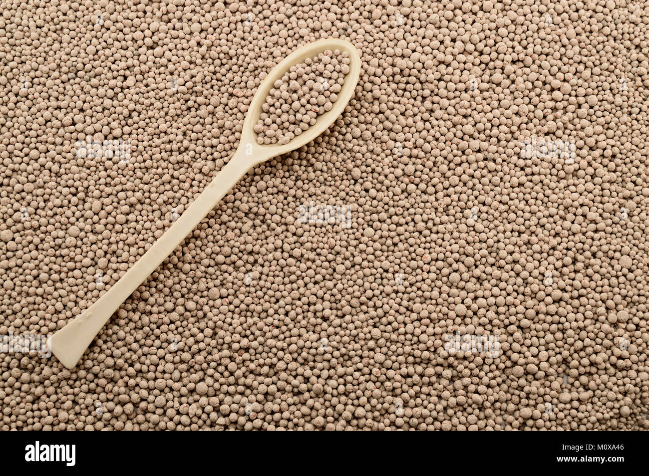 Porcelain laboratory spoon on composite mineral fertilizers Stock Photo ...