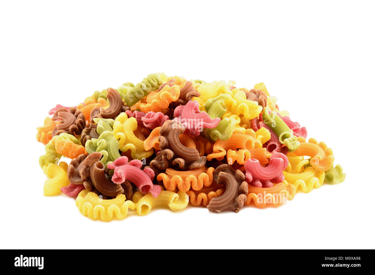 Heap of dry italian pasta in five colours isolated on white background ...