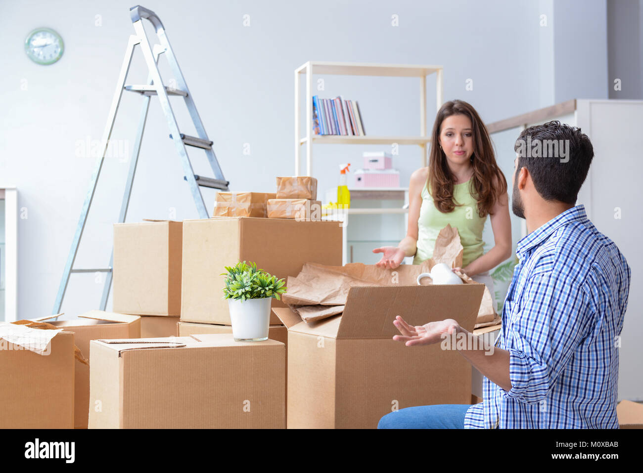 Young family unpacking at new house with boxes Stock Photo - Alamy