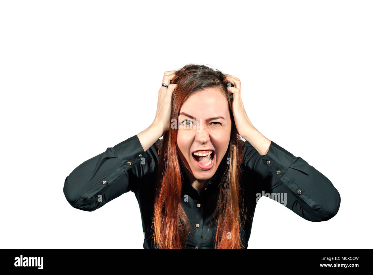 Girl on a white background with extreme expression on her face clasped ...