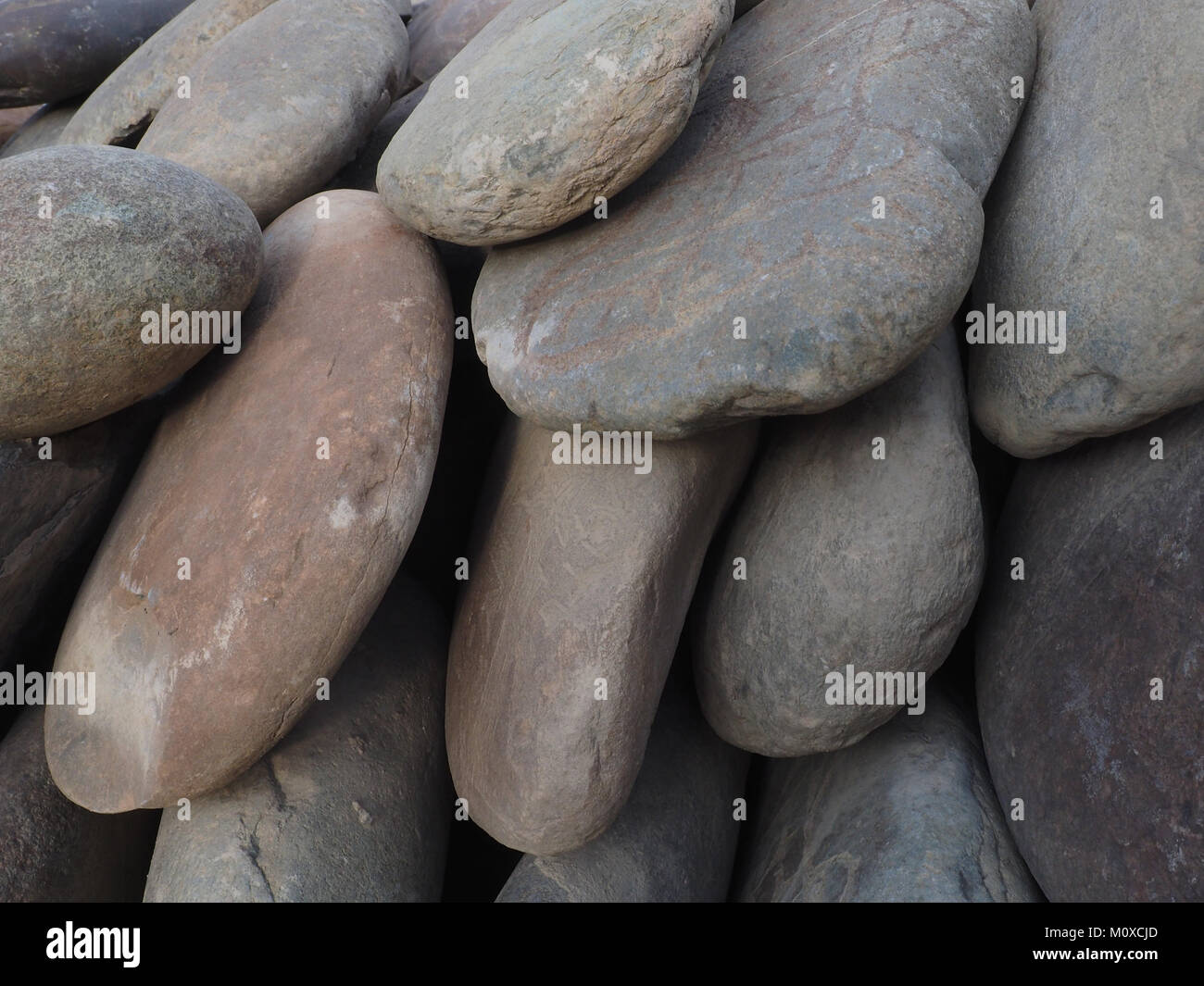 Stretched smooth gray cobblestones, Buddhist stones stacked in a heap ...