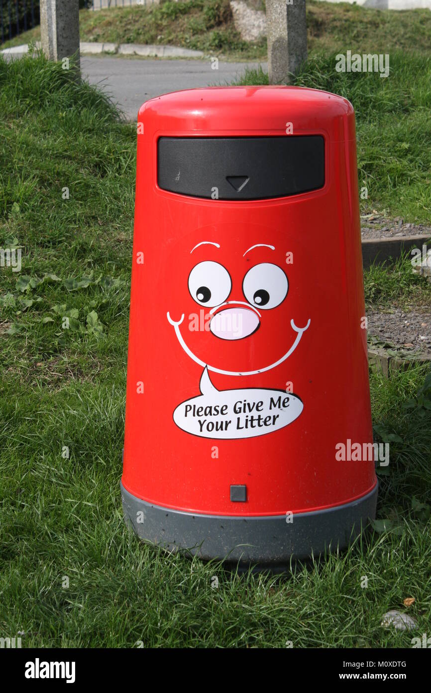 A PORTRAIT SIZE PHOTO OF A RED LITTER BIN IN SUNSHINE IN AN AN ENGLISH ...