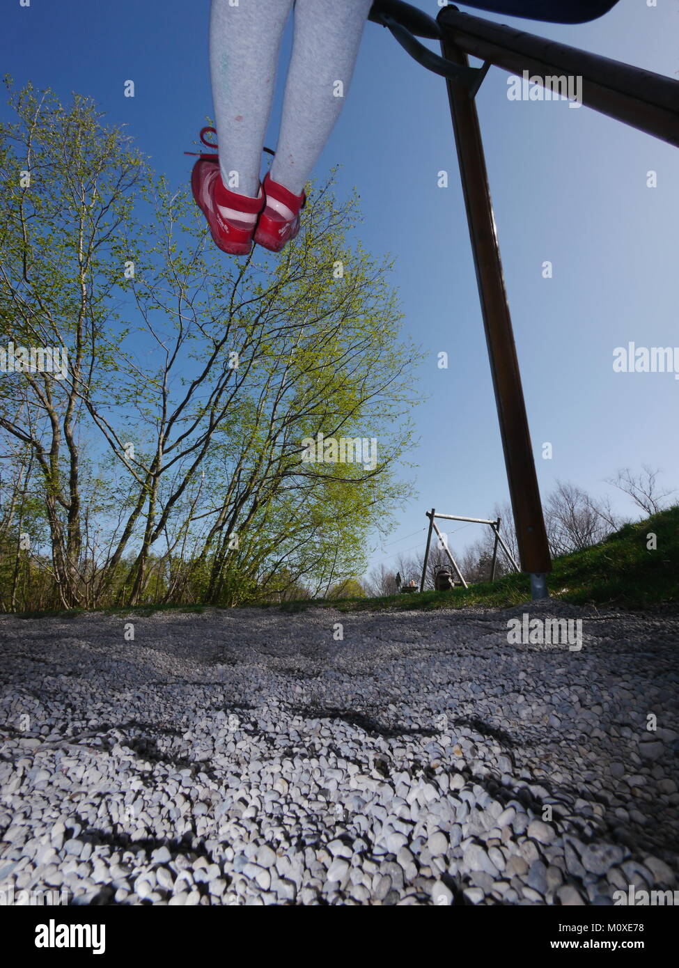 child is swinging very high Stock Photo - Alamy