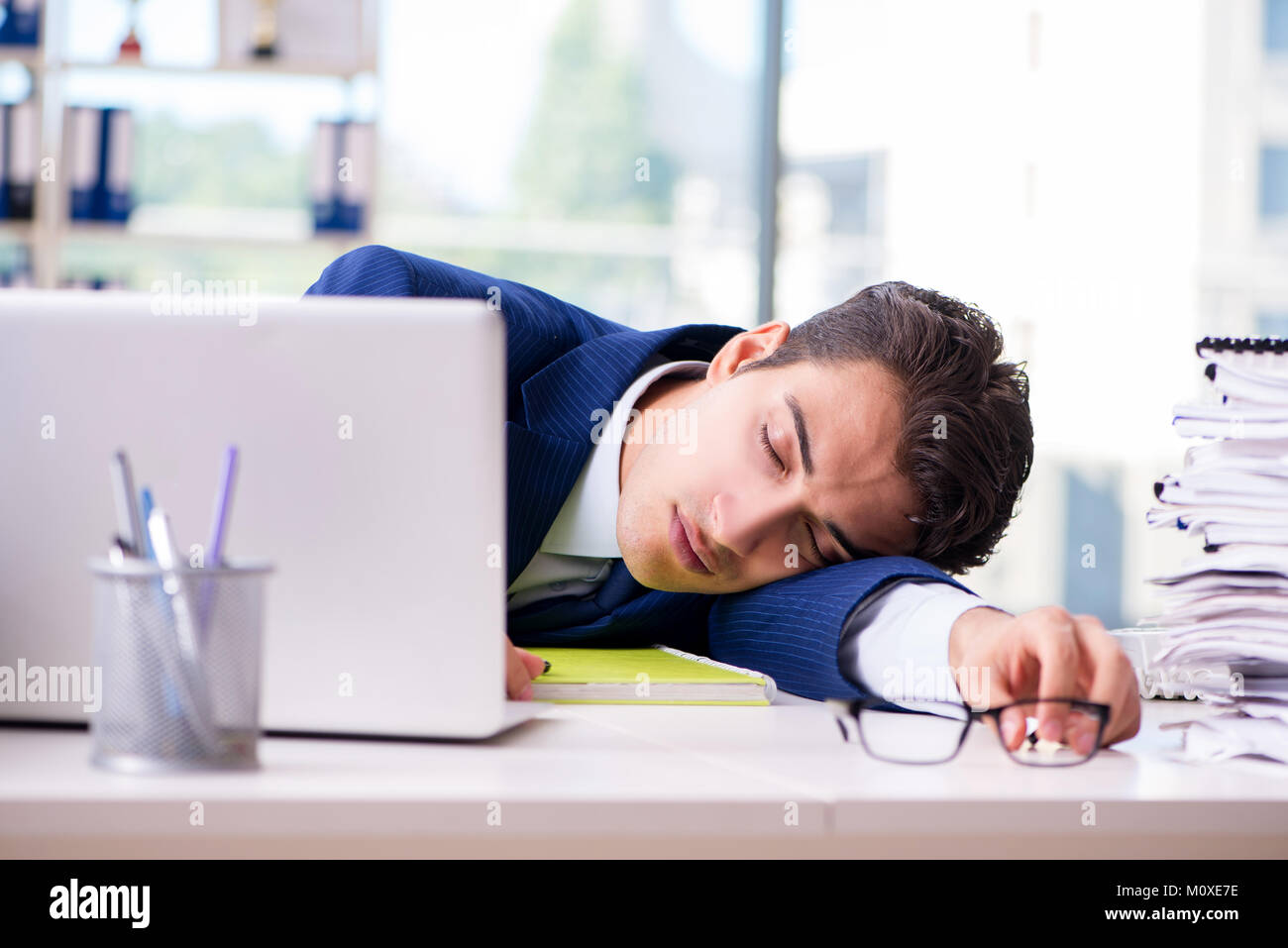Tired businessman exhausted after hard work and excessive workload ...
