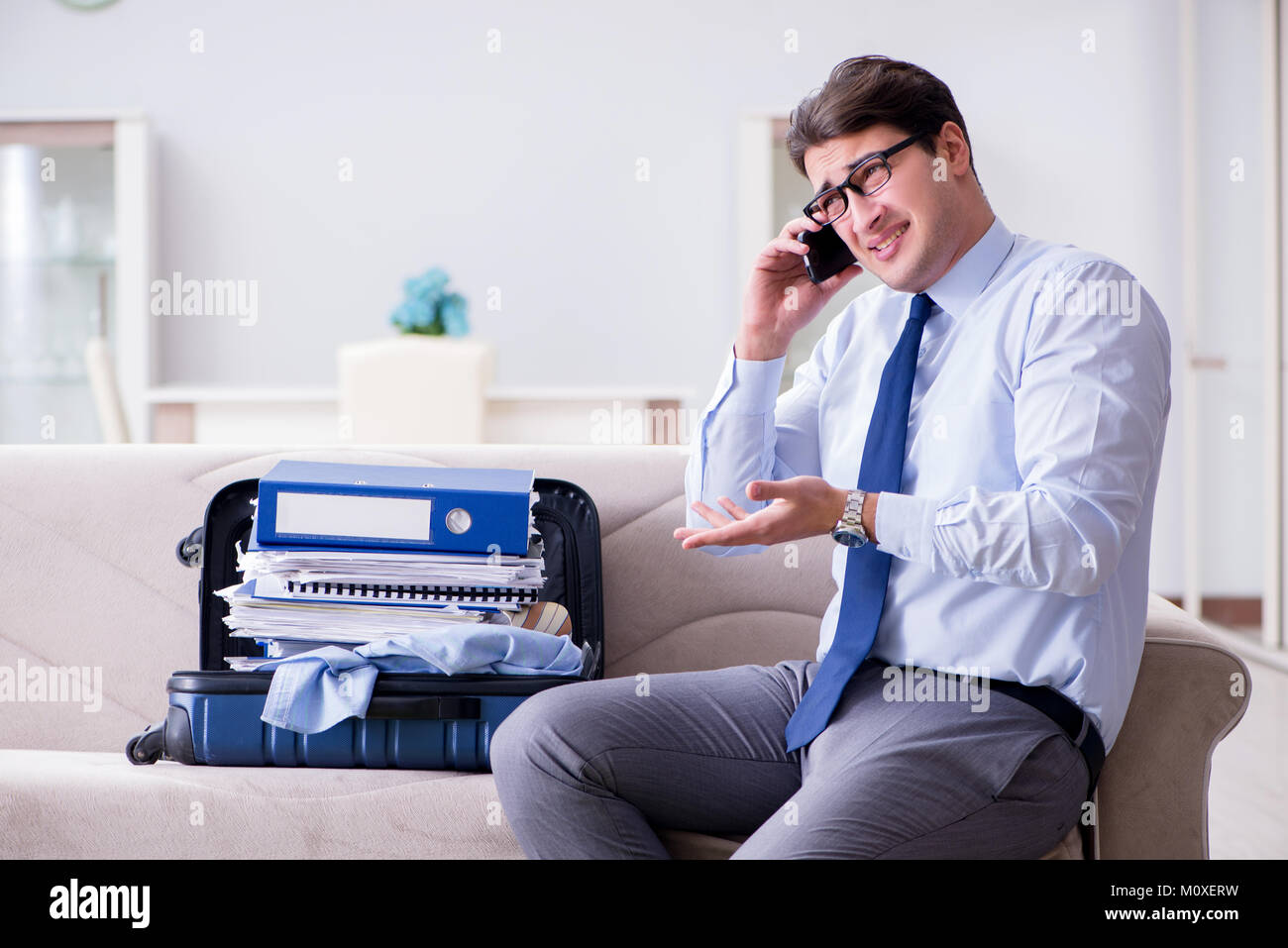Businessman preparing packing for business trip Stock Photo - Alamy
