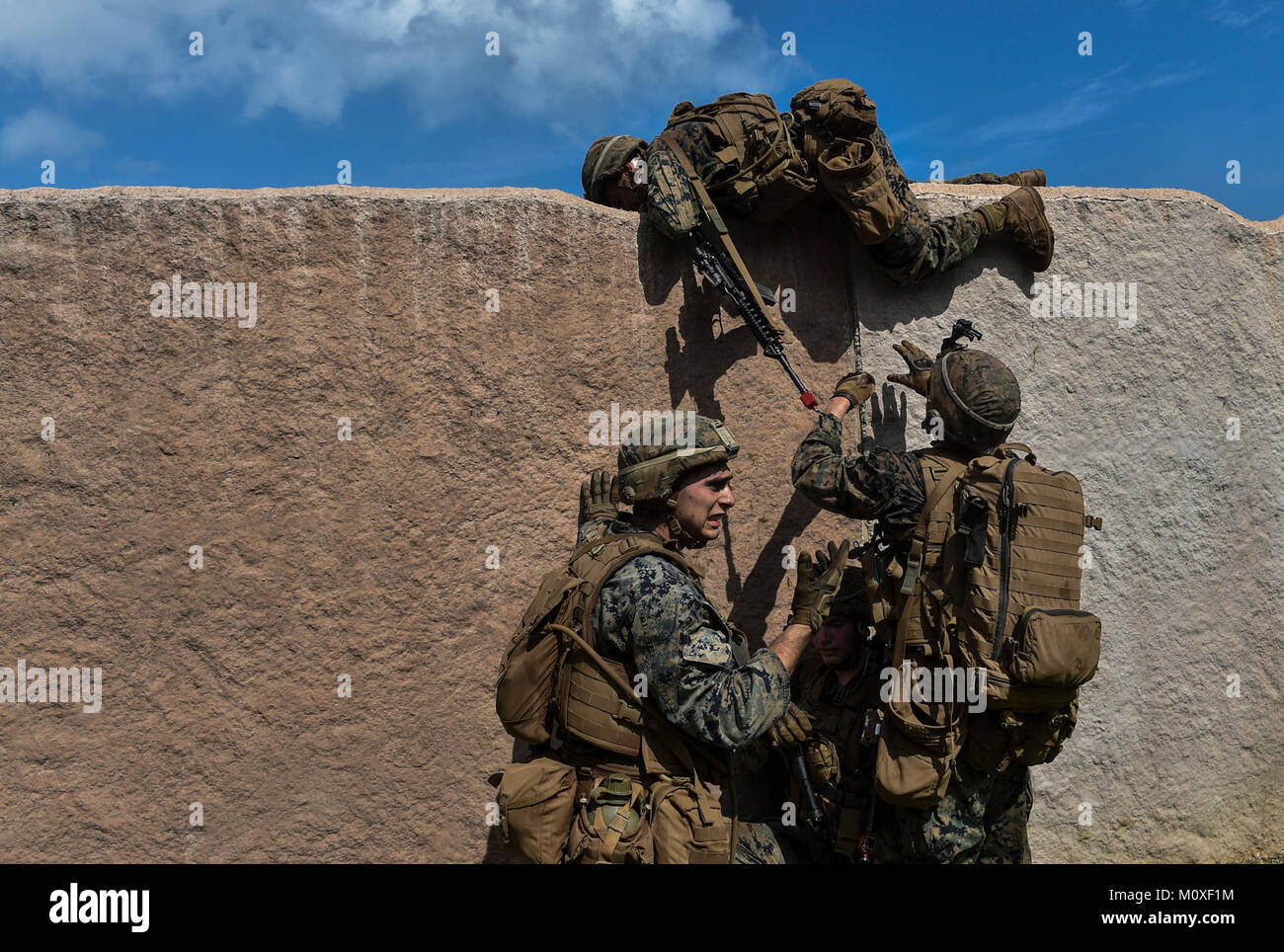 Marines with 3rd Battalion, 3rd Marines climb a perimeter wall to ...