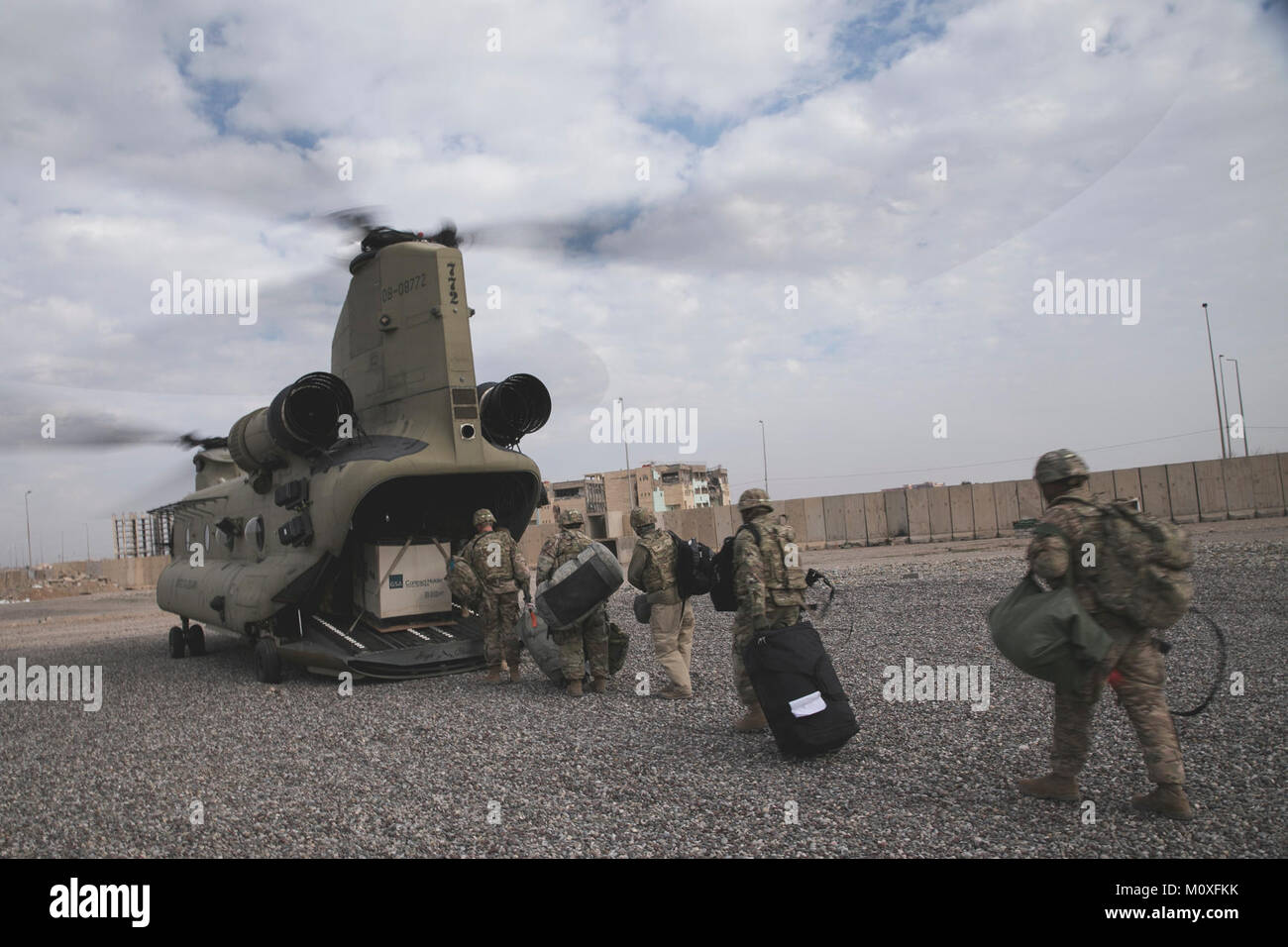 U.S. Soldiers board and load equipment onto a CH-47 Chinook helicopter ...