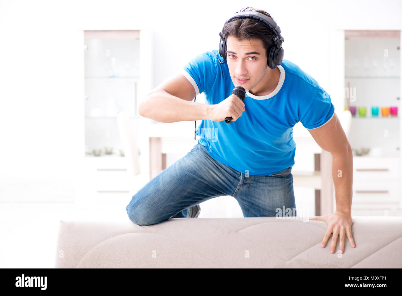 Young man singing at home karaoke Stock Photo - Alamy