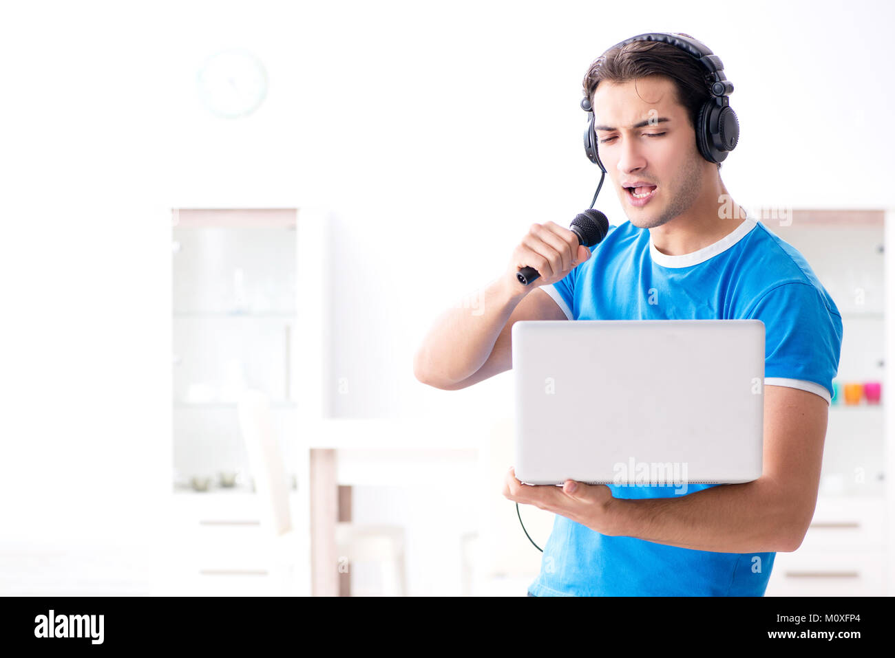 Young man singing at home karaoke Stock Photo - Alamy