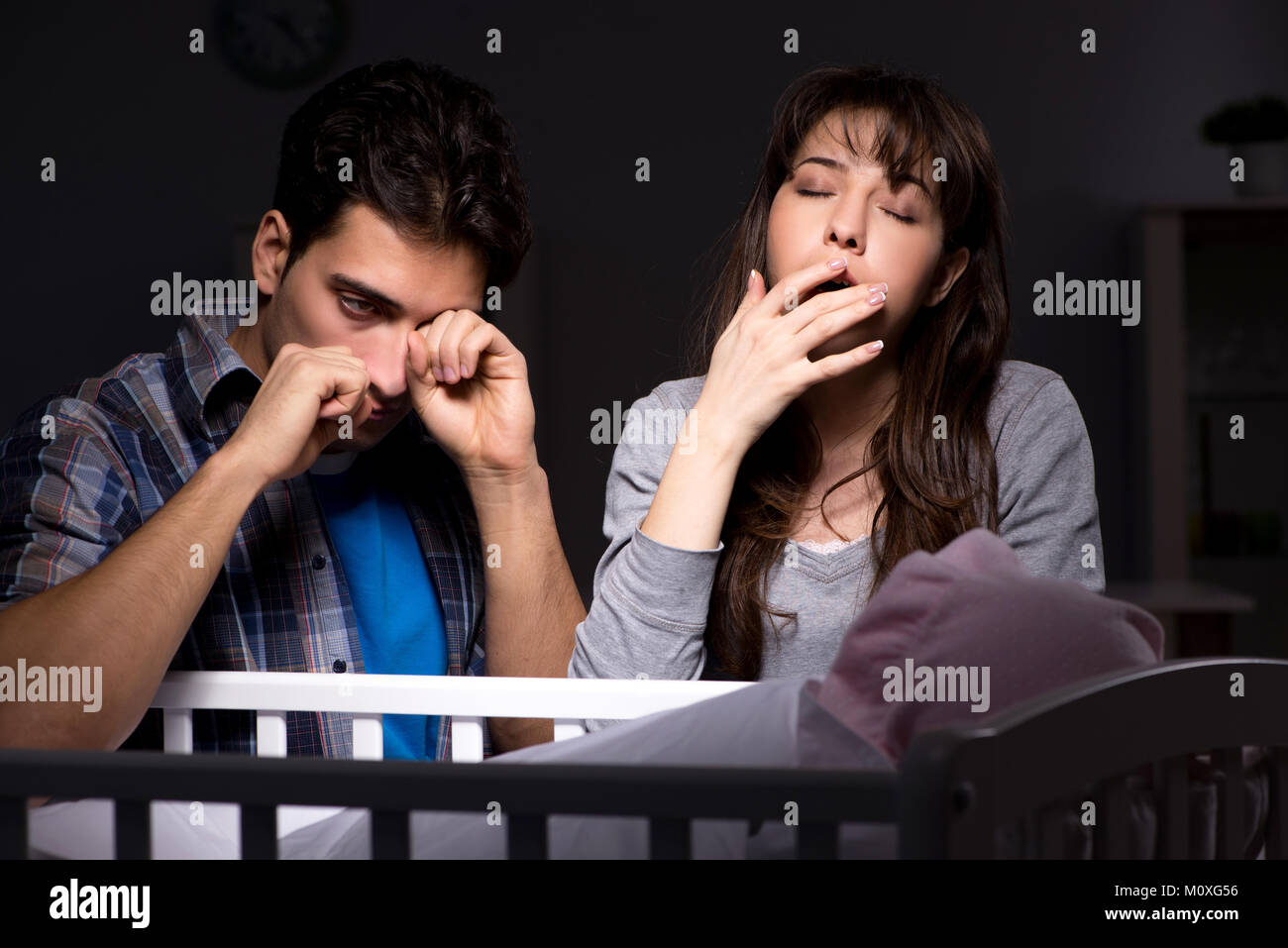 Young parents sleepless with newborn baby at night Stock Photo - Alamy