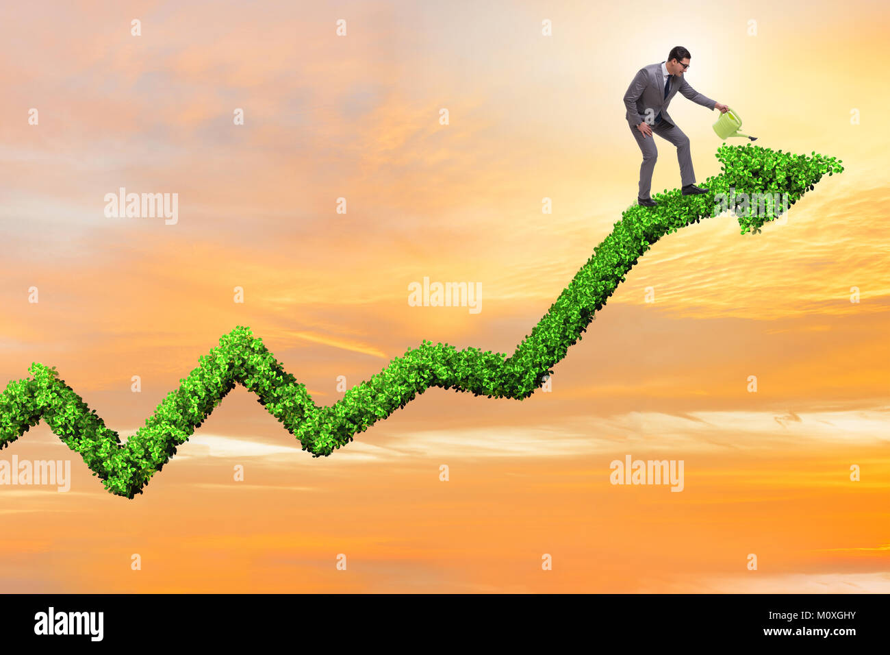 Businessman in investment concept watering financial line chart Stock ...