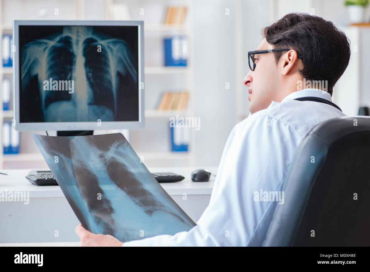 Doctor radiologist looking at x-ray images Stock Photo - Alamy