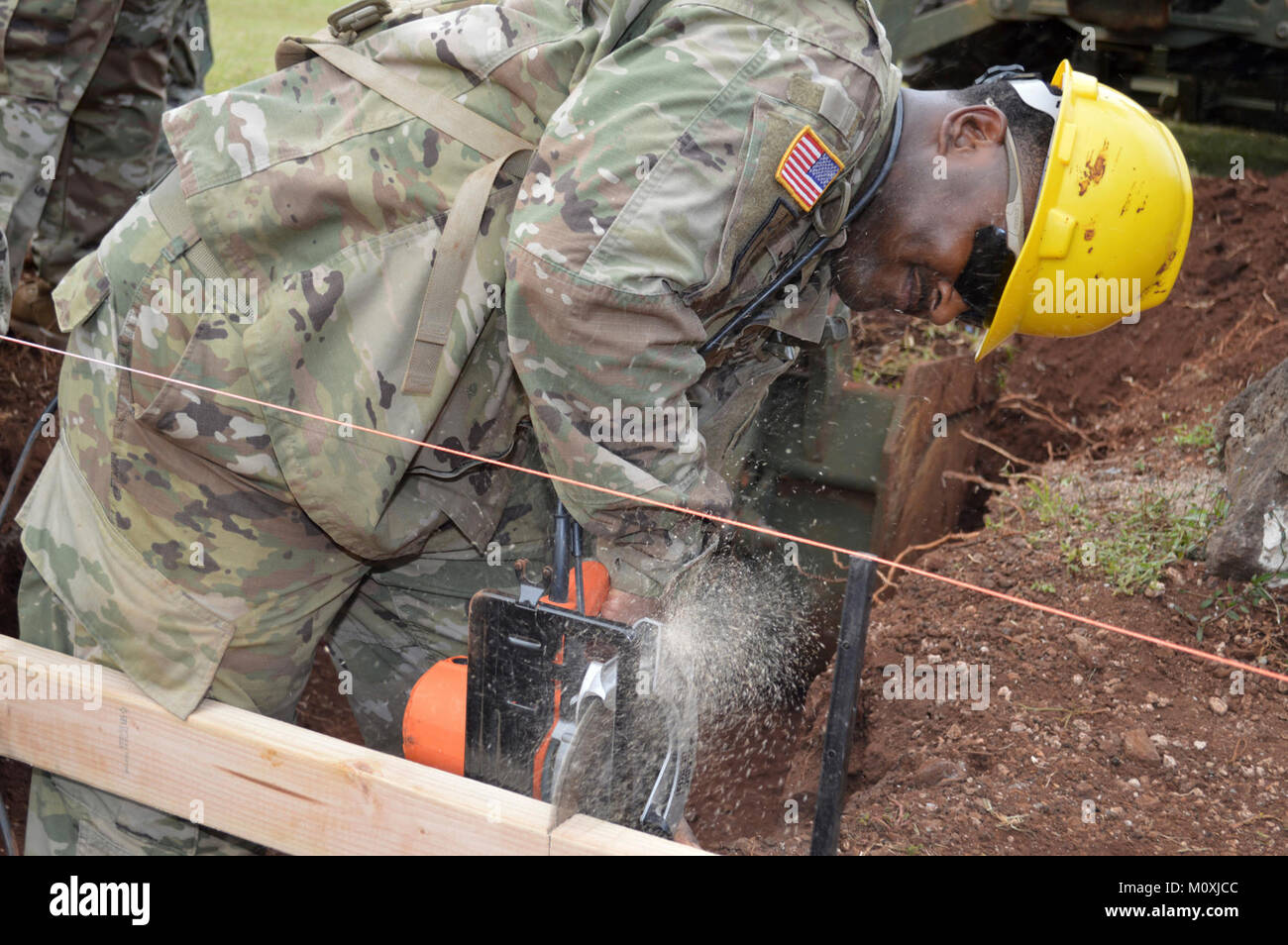 Sgt. Deon Johnson, an interior electrician assigned to the uses a ...