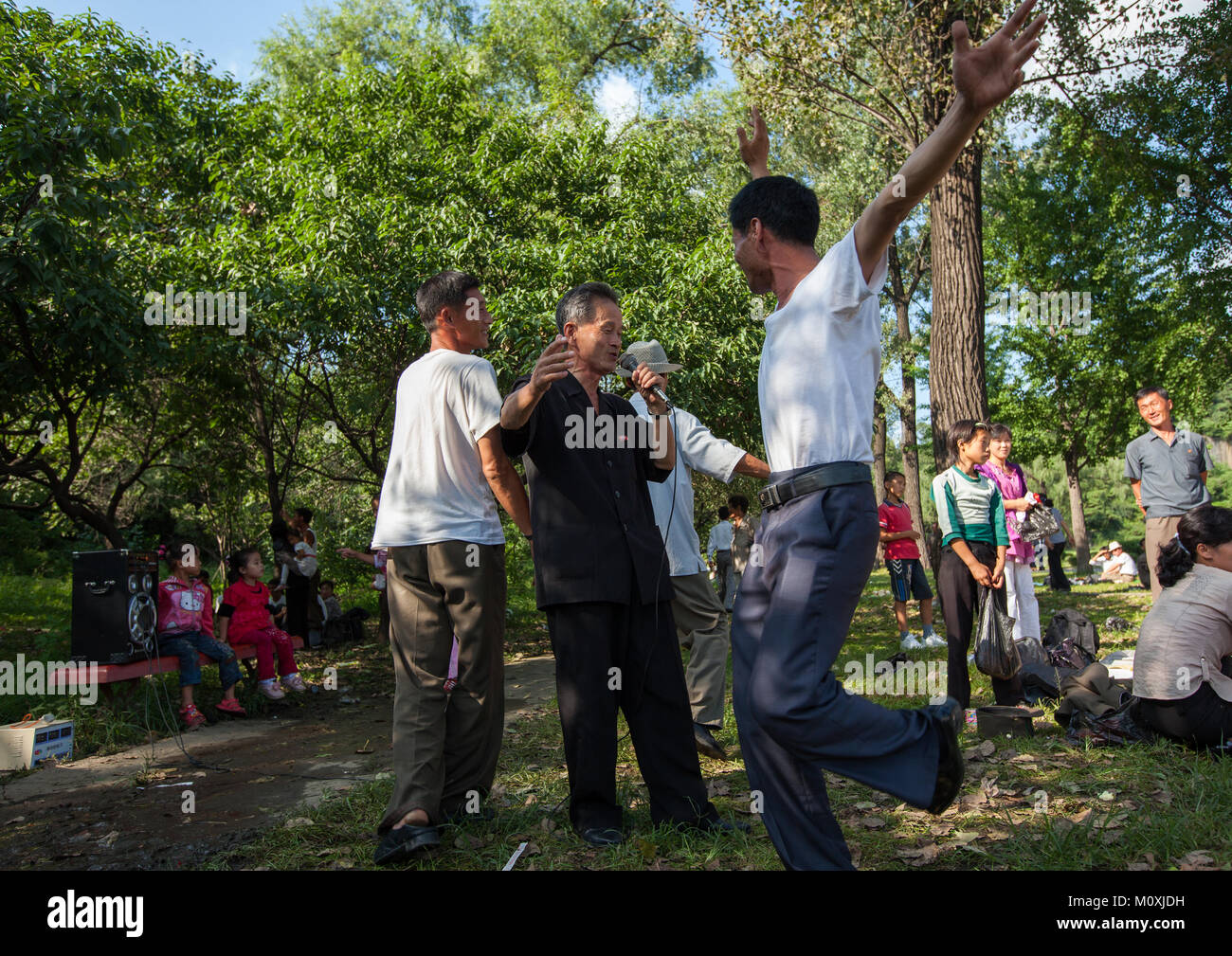 North Korean men singing in a park on national day, Pyongan Province ...