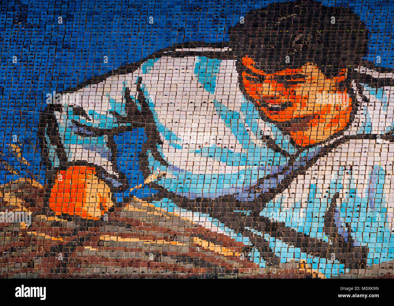 North Korean man breaking a brick made by children pixels holding up ...