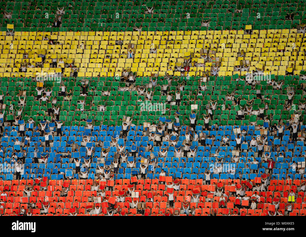 Children used to make human pixels by holding up colored boards during ...