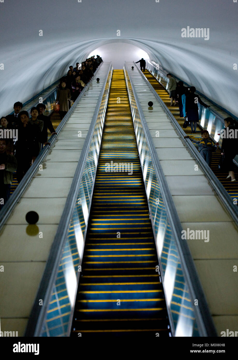 North Korean people using escalator leading to the subway station ...