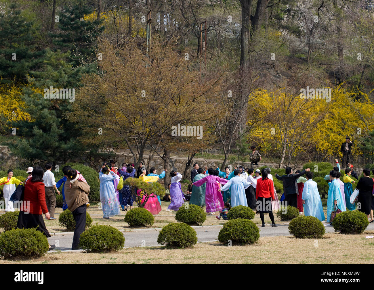 North Korean people dancing in a park for the day of the sun which is ...