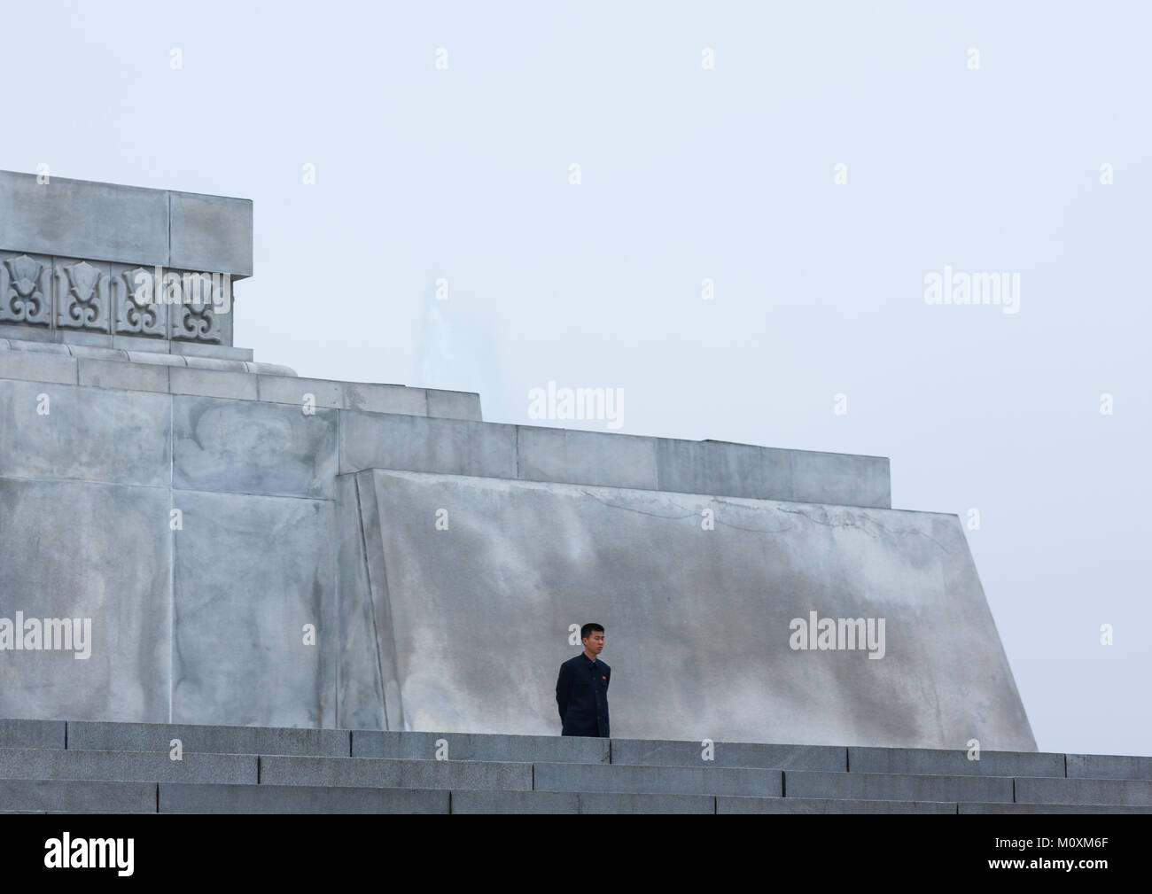 North Korean man standing at the bottom of Juche tower, Pyongan ...