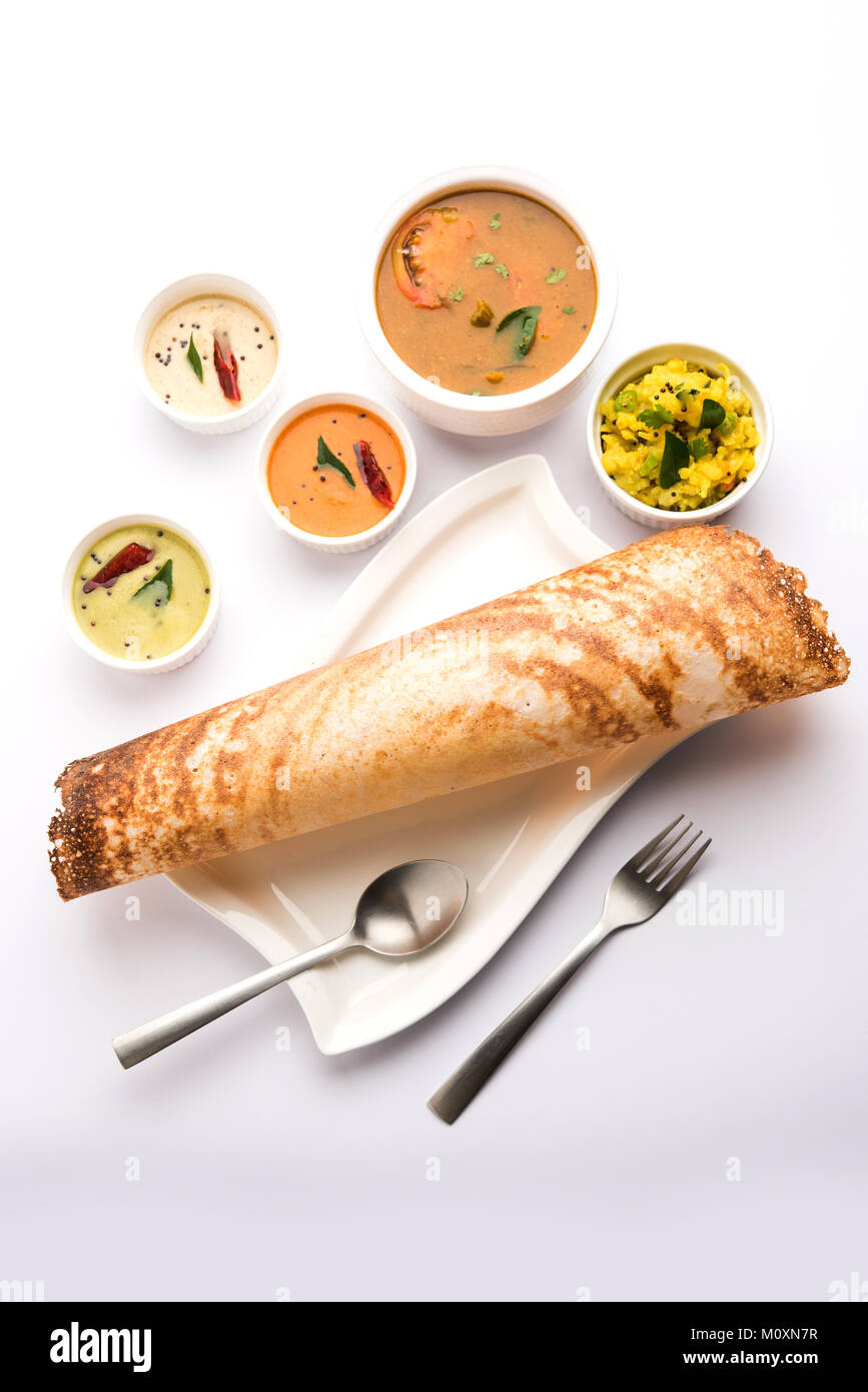 Masala dosa with chutney and sambar and potato sabzi. Cone, triangle or ...