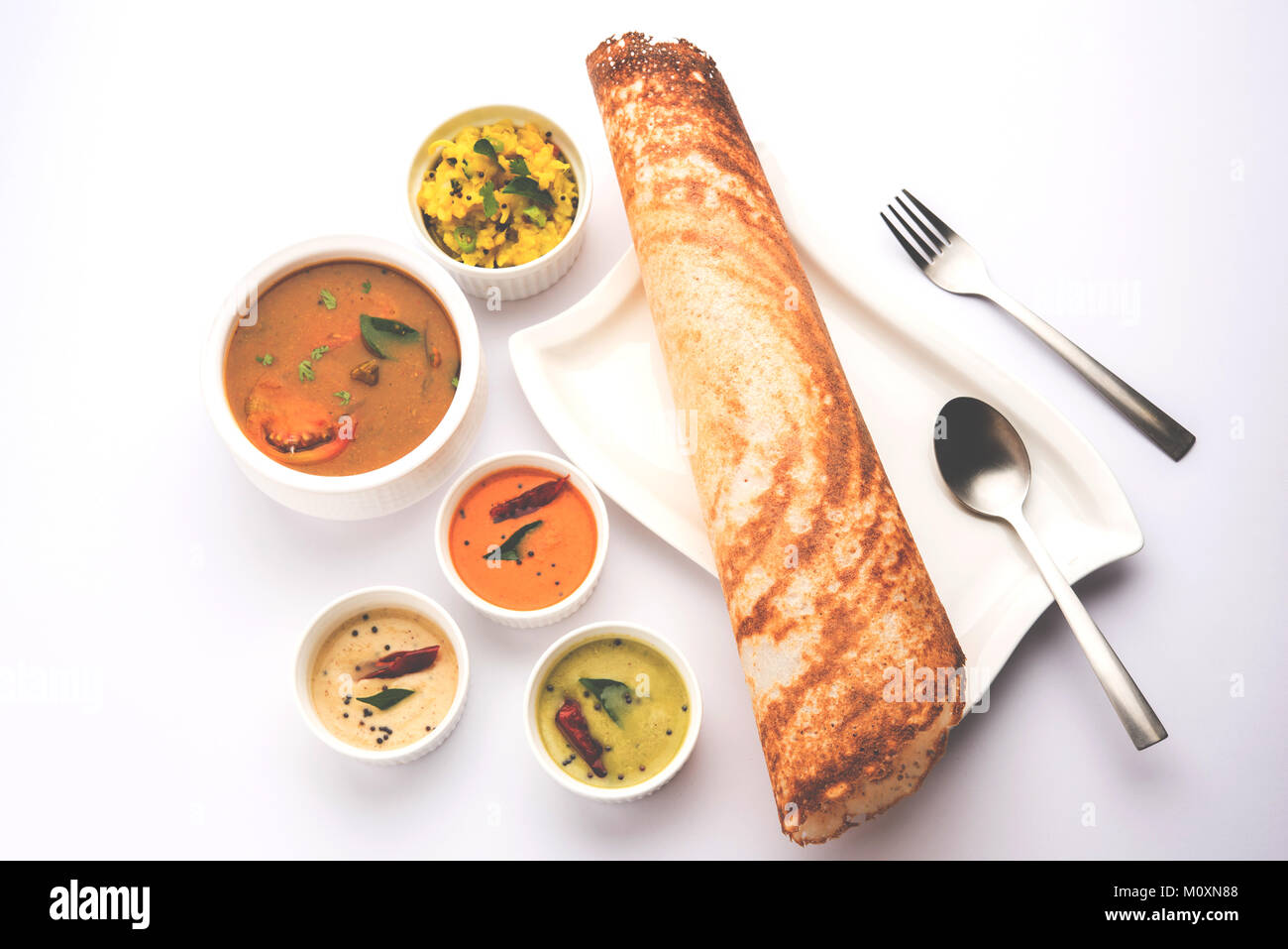 Masala dosa with chutney and sambar and potato sabzi. Cone, triangle or ...