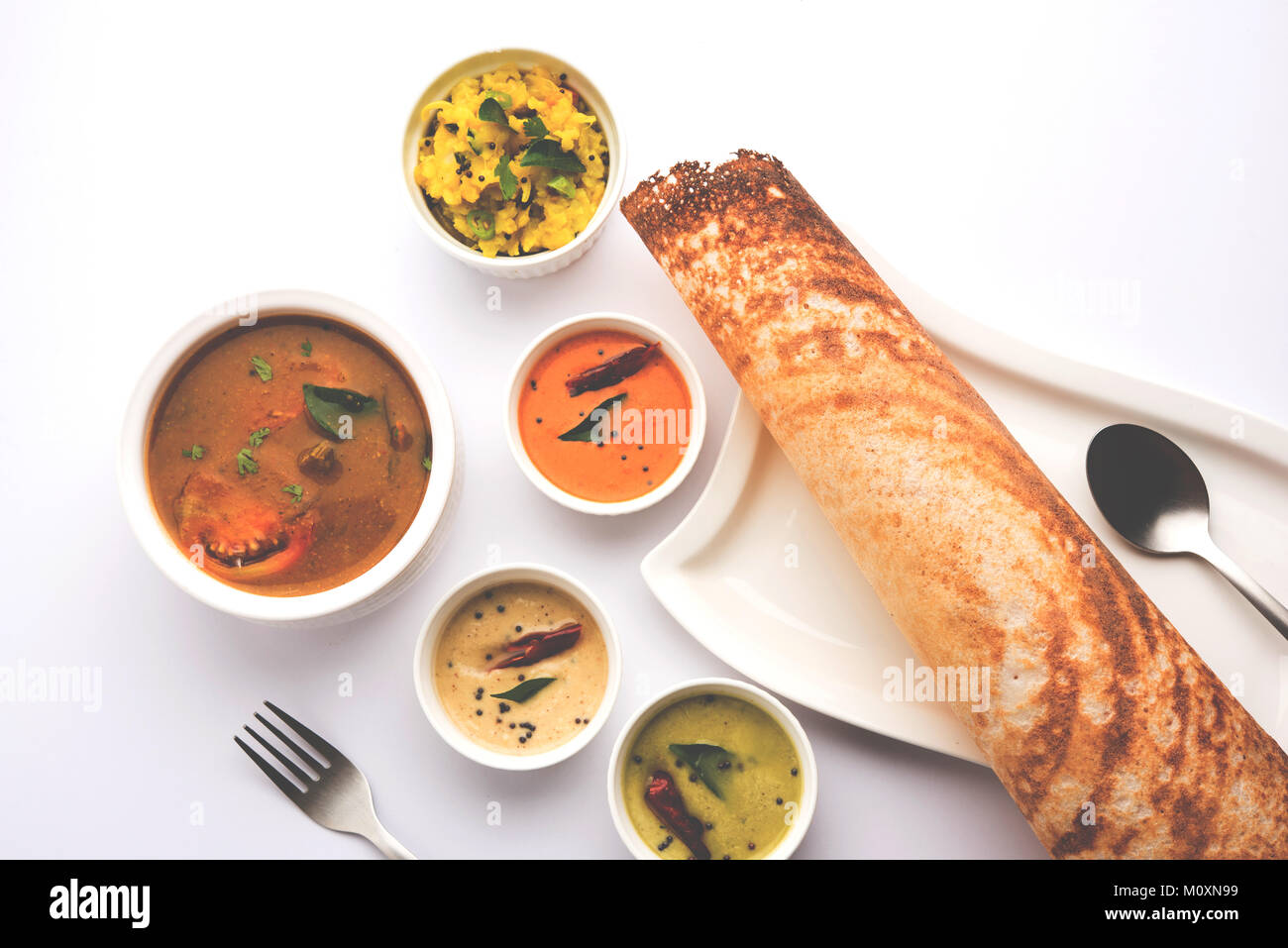 Masala dosa with chutney and sambar and potato sabzi. Cone, triangle or ...