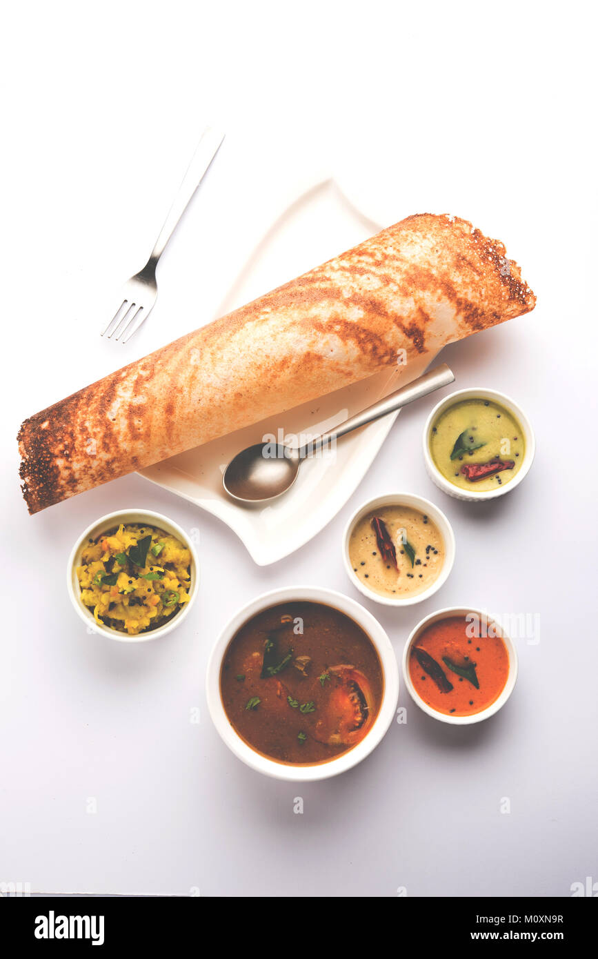 Masala dosa with chutney and sambar and potato sabzi. Cone, triangle or ...