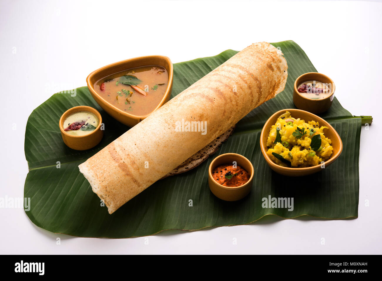 Masala dosa with chutney and sambar and potato sabzi. Cone, triangle or ...