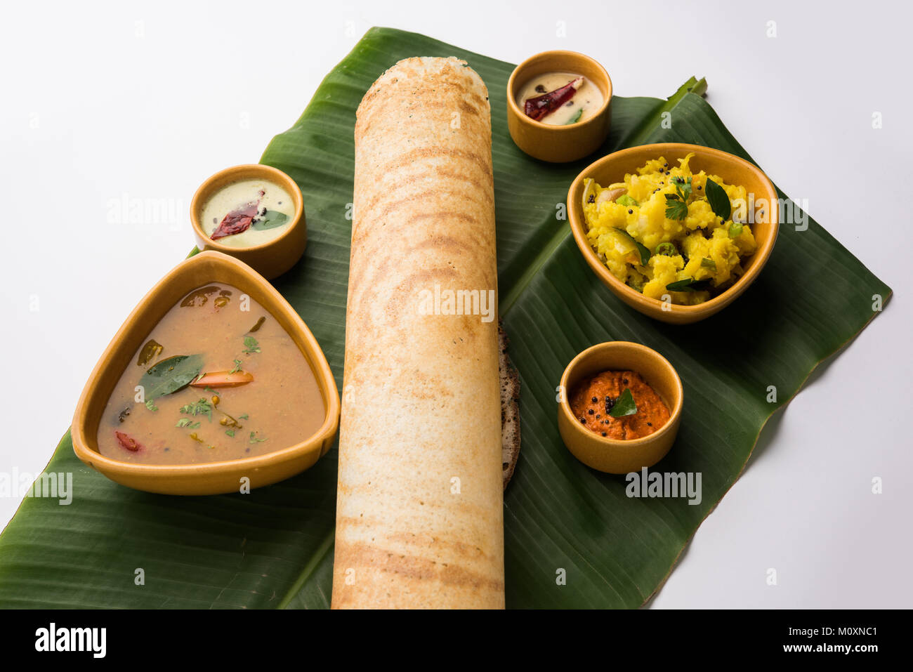 Masala dosa with chutney and sambar and potato sabzi. Cone, triangle or ...