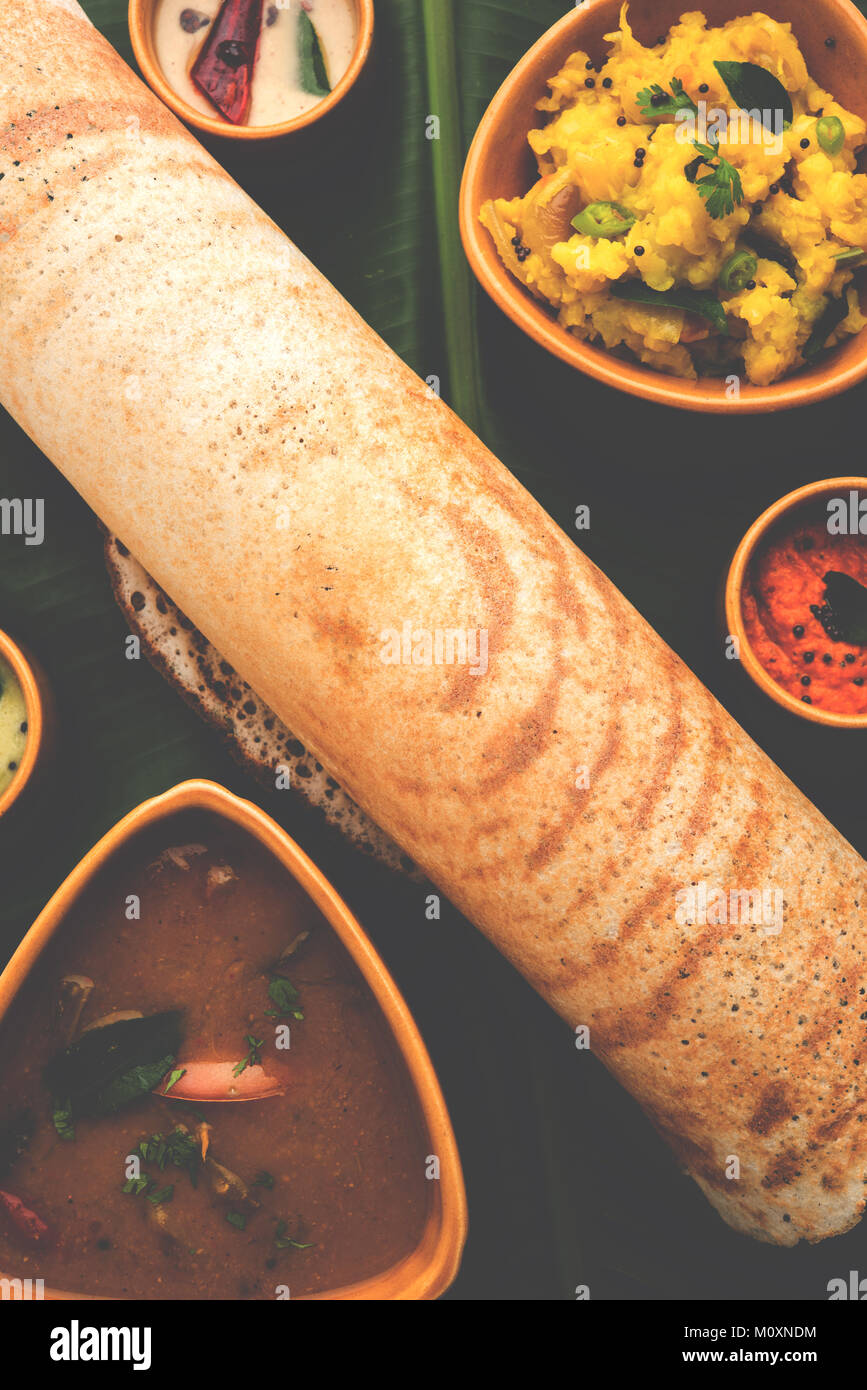 Masala dosa with chutney and sambar and potato sabzi. Cone, triangle or ...