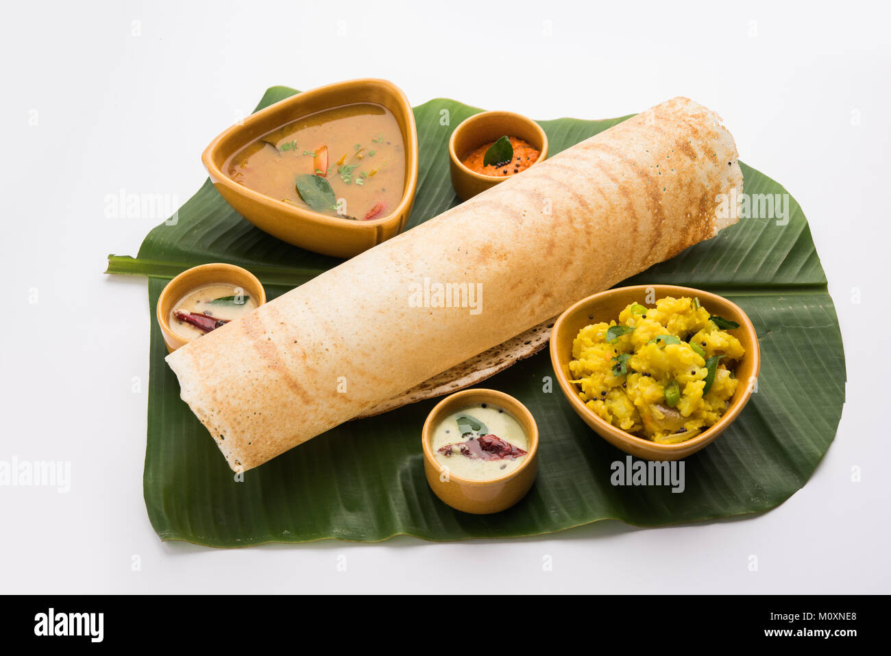 Masala dosa with chutney and sambar and potato sabzi. Cone, triangle or ...