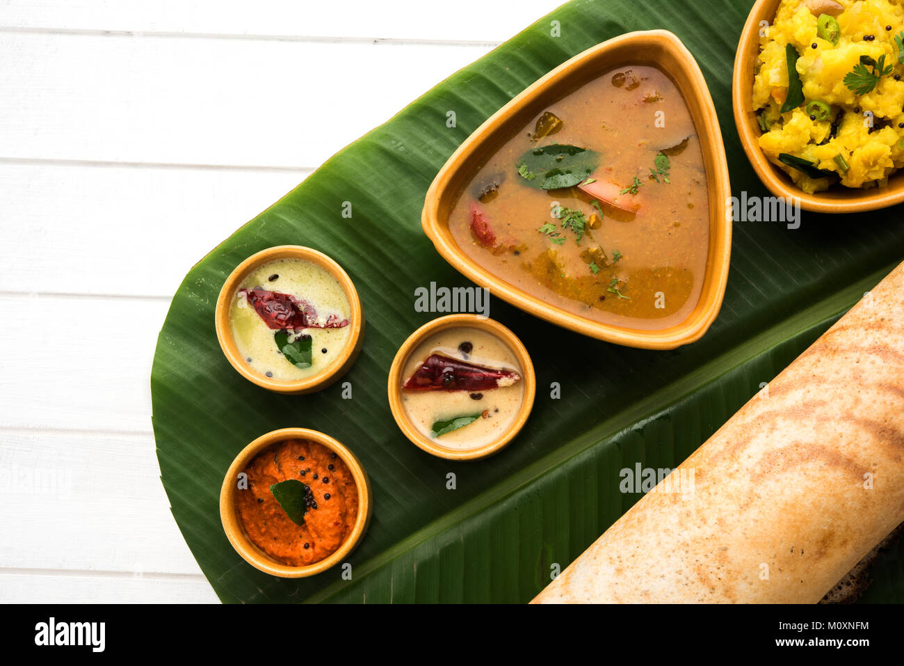Masala dosa with chutney and sambar and potato sabzi. Cone, triangle or ...
