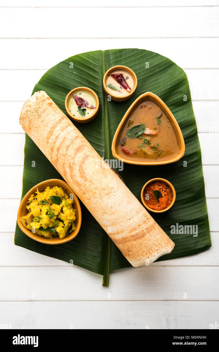 Masala dosa with chutney and sambar and potato sabzi. Cone, triangle or ...