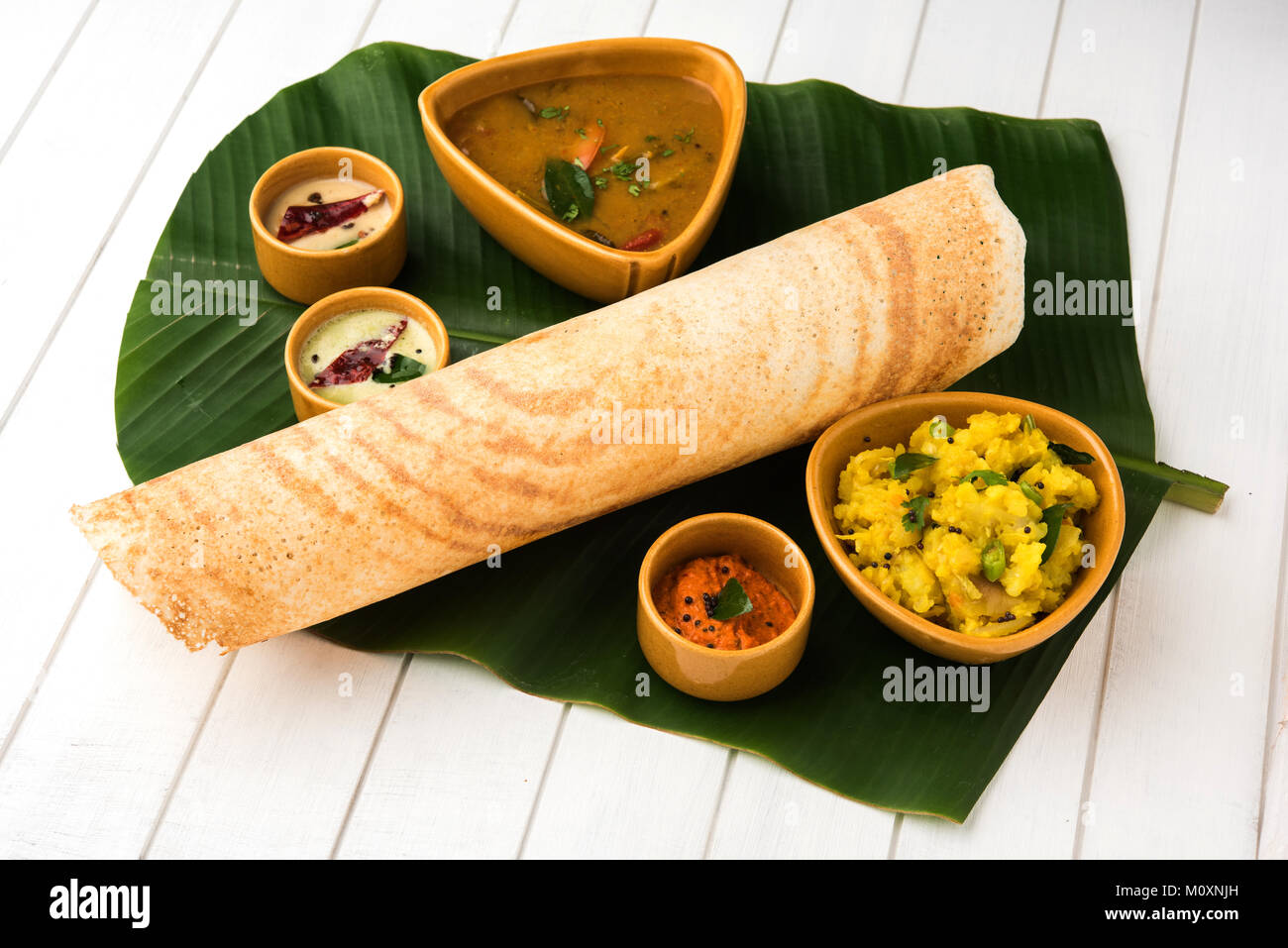 Masala dosa with chutney and sambar and potato sabzi. Cone, triangle or ...