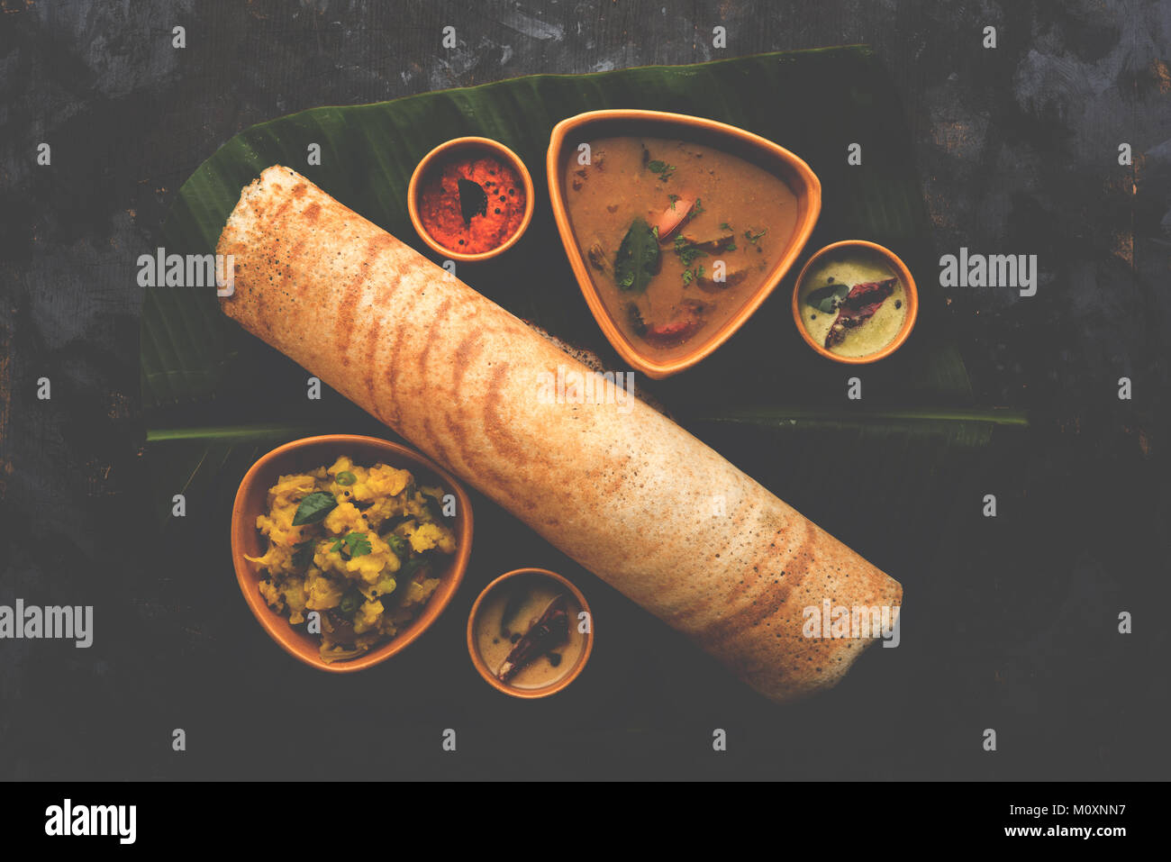 Masala dosa with chutney and sambar and potato sabzi. Cone, triangle or ...