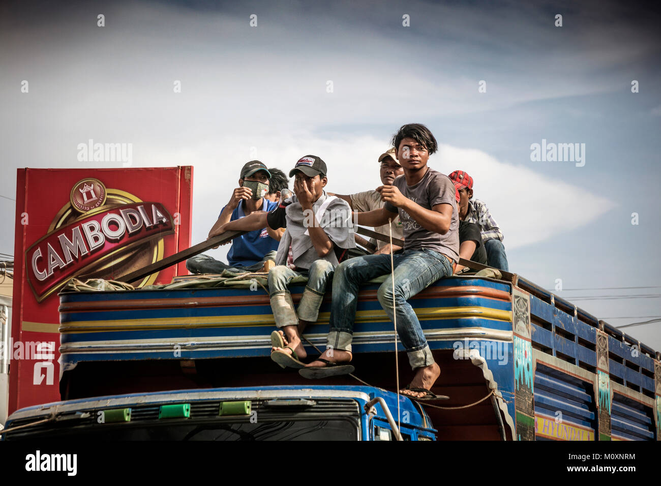 Cambodians riding on roof of lorry, Sangkat Kouk Chat, Krong Siem Reap ...
