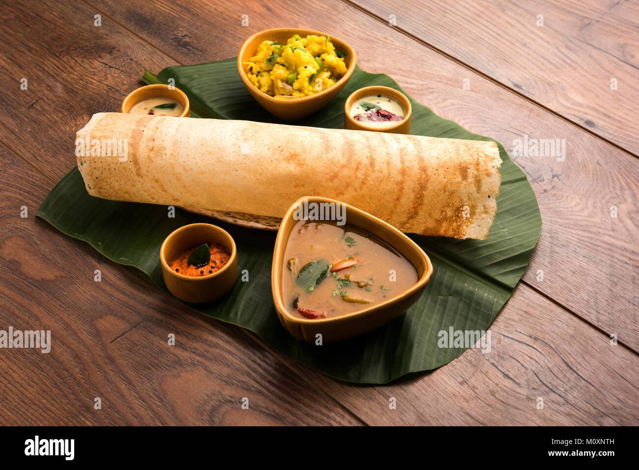 Masala dosa with chutney and sambar and potato sabzi. Cone, triangle or ...