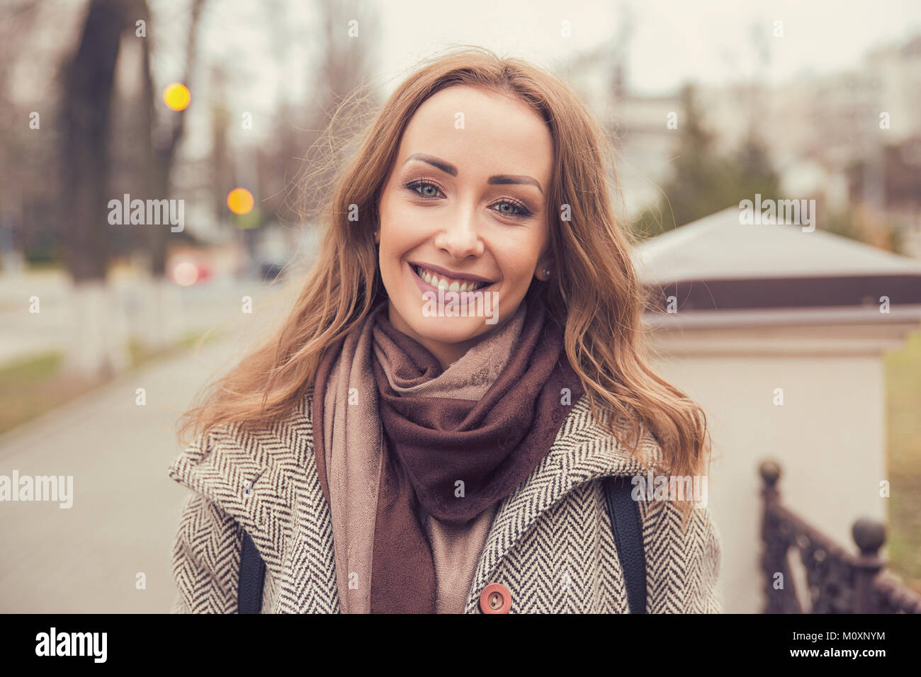 Portrait of charming elegant lady smiling at camera posing in winter ...