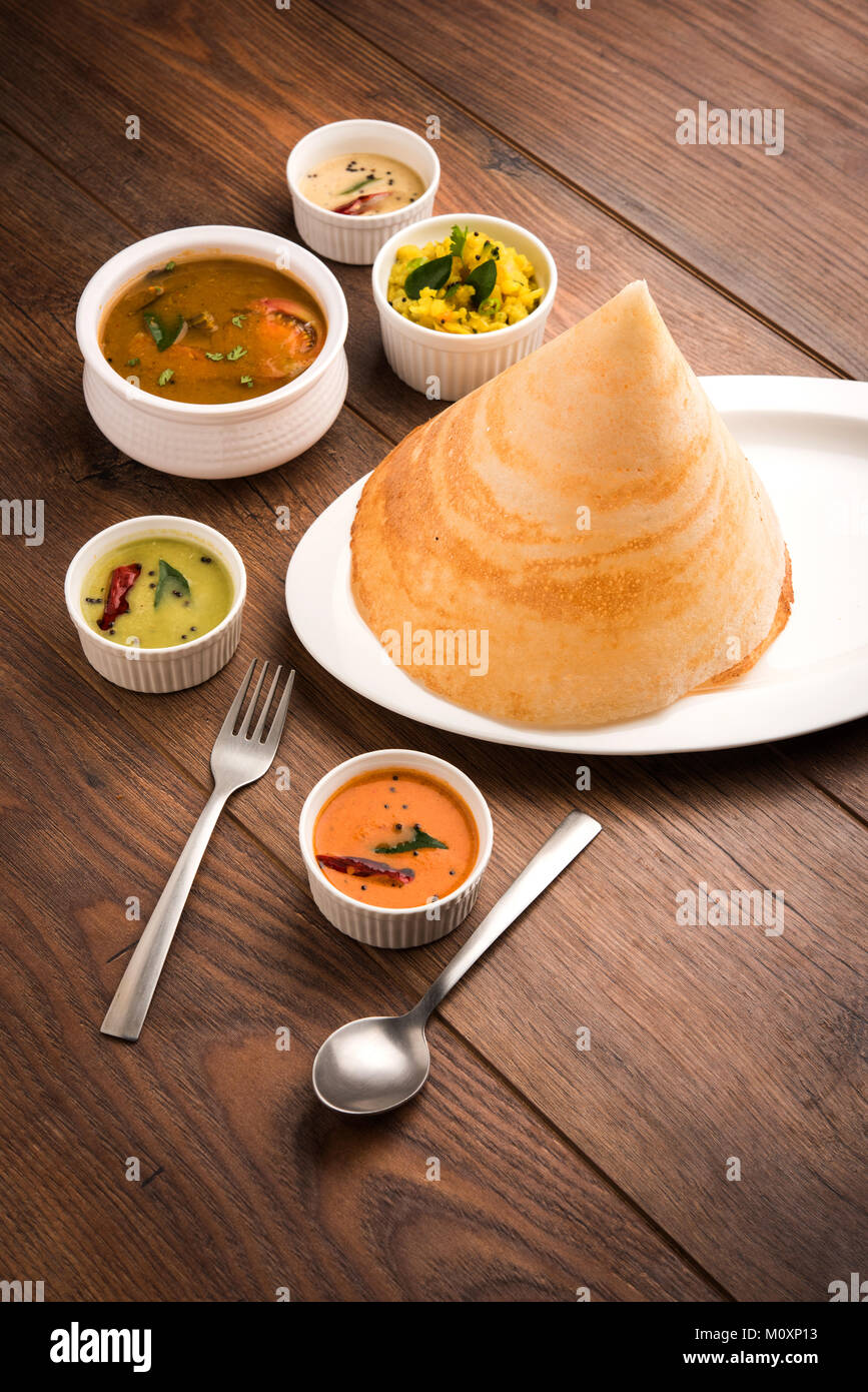 Masala dosa with chutney and sambar and potato sabzi. Cone, triangle or ...