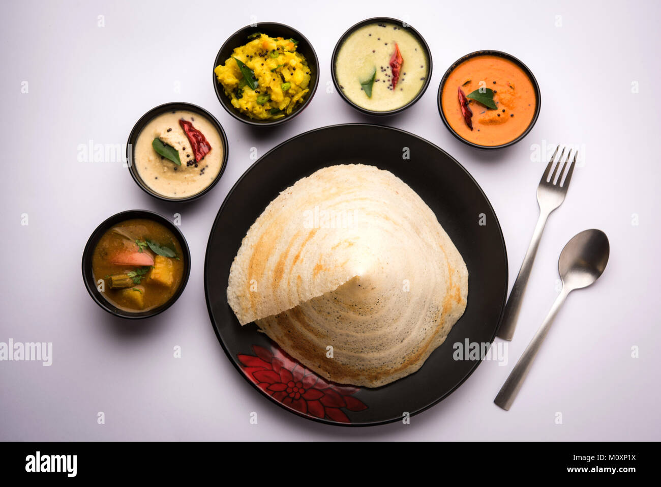 Masala dosa with chutney and sambar and potato sabzi. Cone, triangle or ...