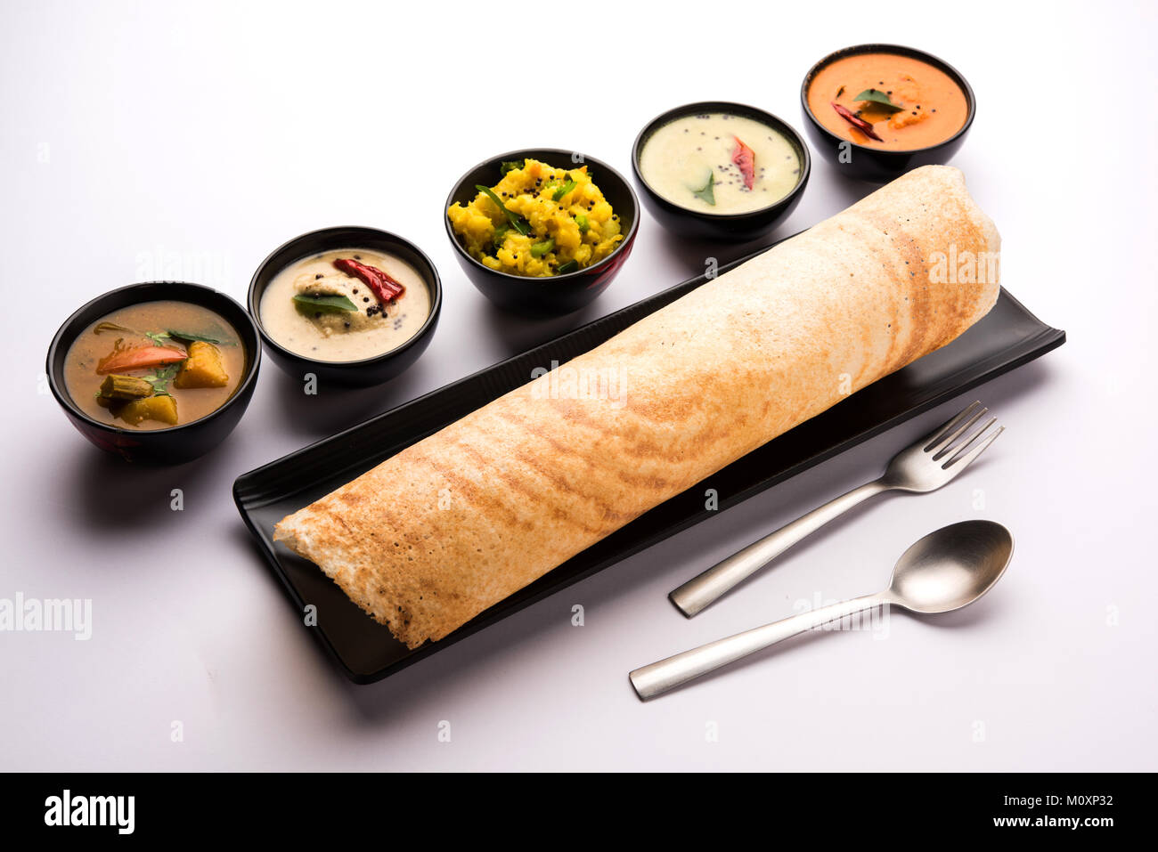Masala dosa with chutney and sambar and potato sabzi. Cone, triangle or ...