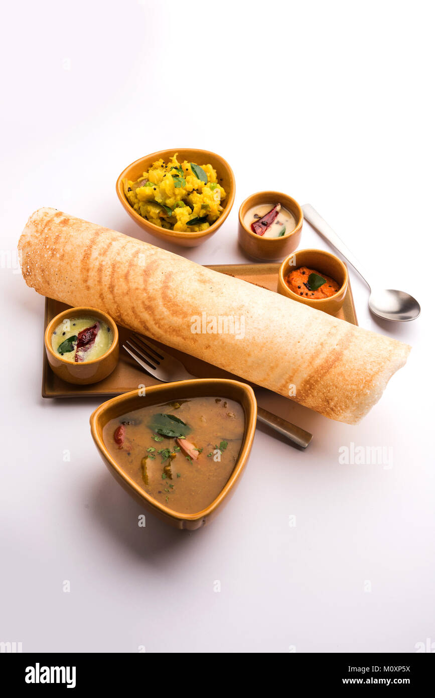 Masala dosa with chutney and sambar and potato sabzi. Cone, triangle or ...