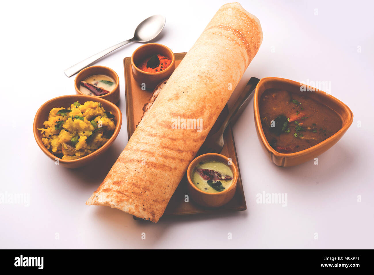 Masala dosa with chutney and sambar and potato sabzi. Cone, triangle or ...