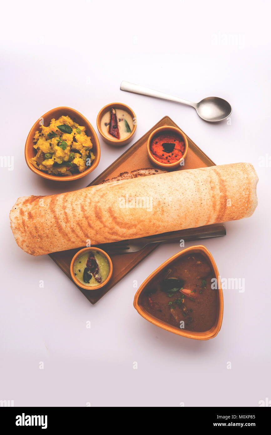 Masala dosa with chutney and sambar and potato sabzi. Cone, triangle or ...