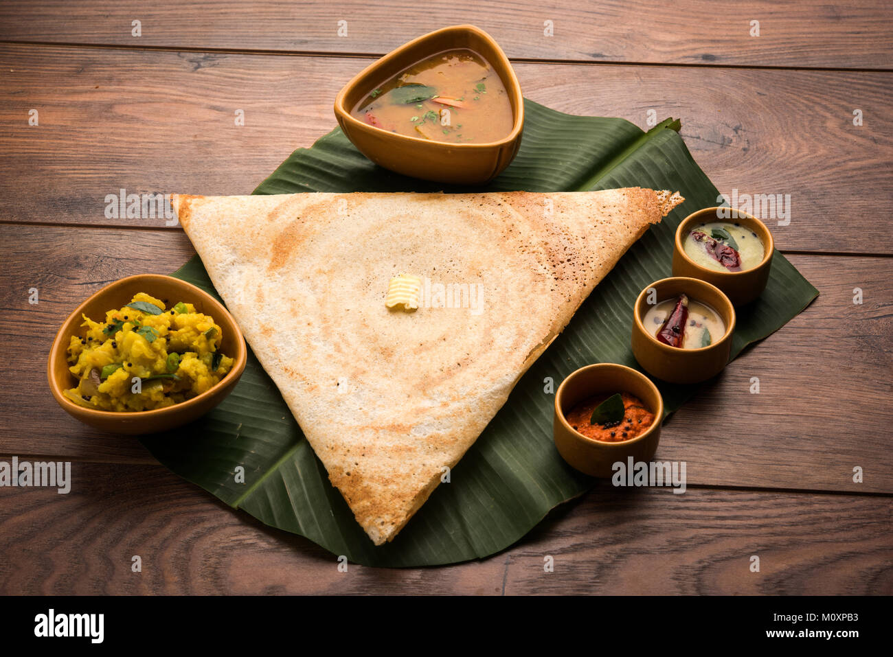 Masala dosa with chutney and sambar and potato sabzi. Cone, triangle or ...