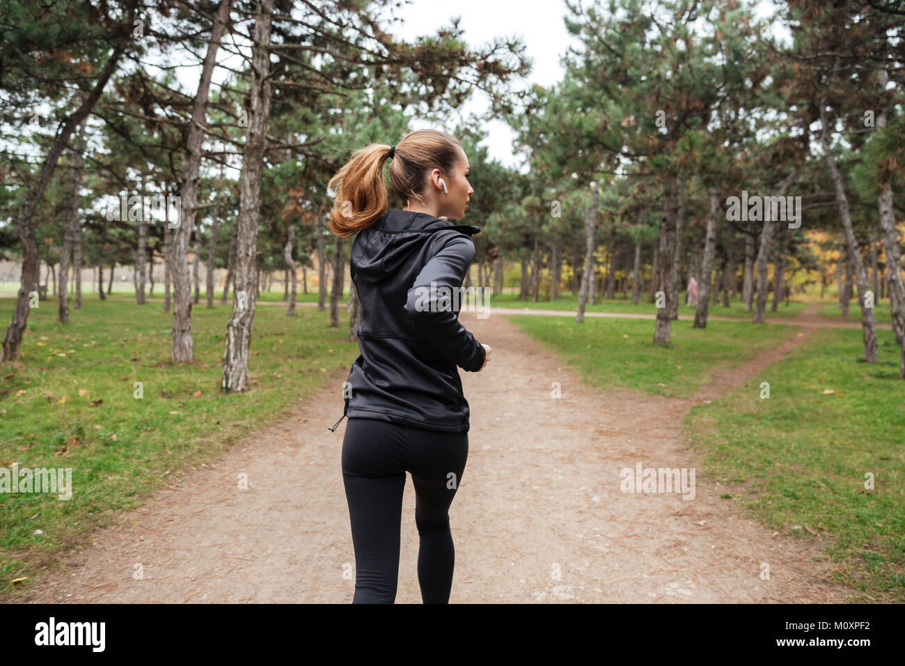 Back view of a fitness woman jogging outdoors Stock Photo - Alamy