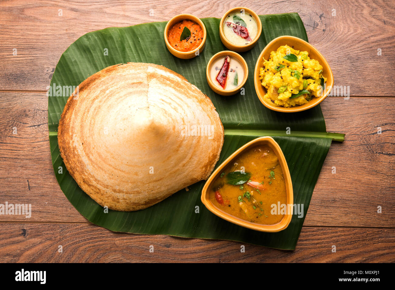 Masala dosa with chutney and sambar and potato sabzi. Cone, triangle or ...
