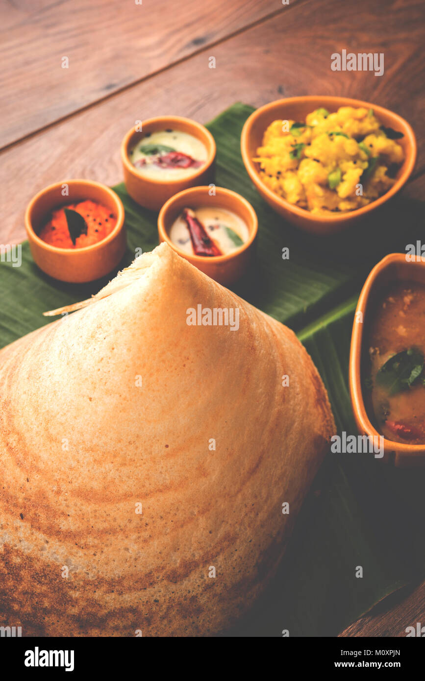 Masala dosa with chutney and sambar and potato sabzi. Cone, triangle or ...