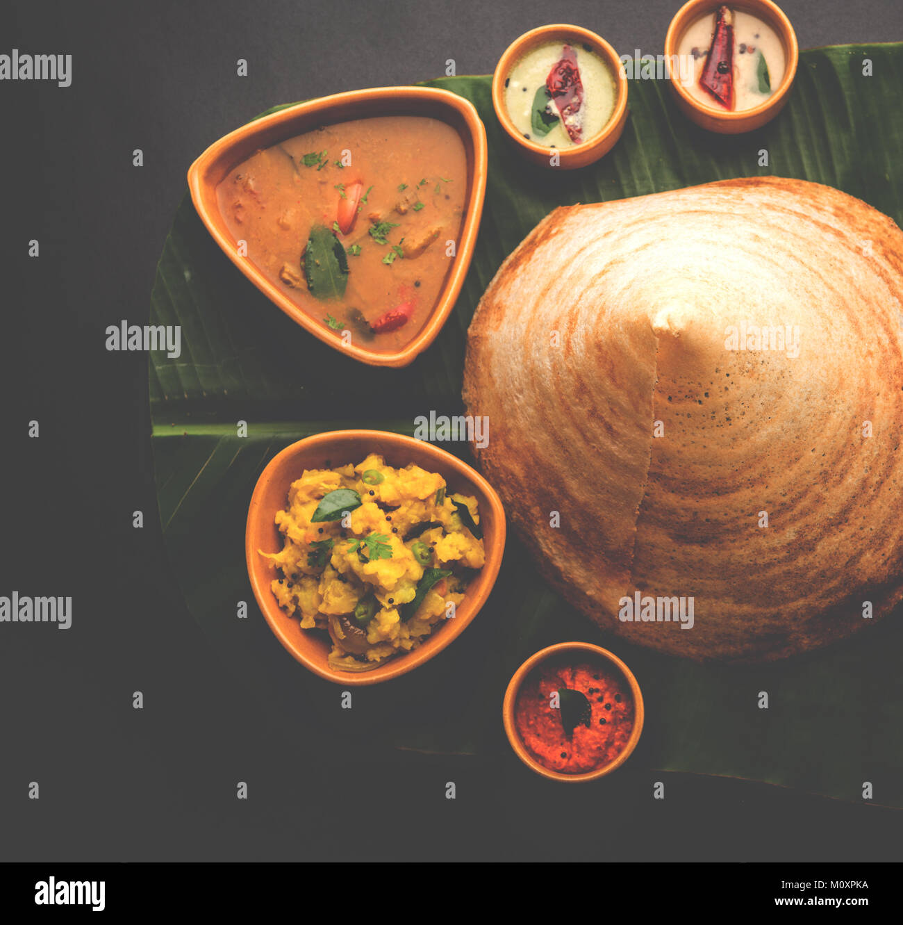 Masala dosa with chutney and sambar and potato sabzi. Cone, triangle or ...